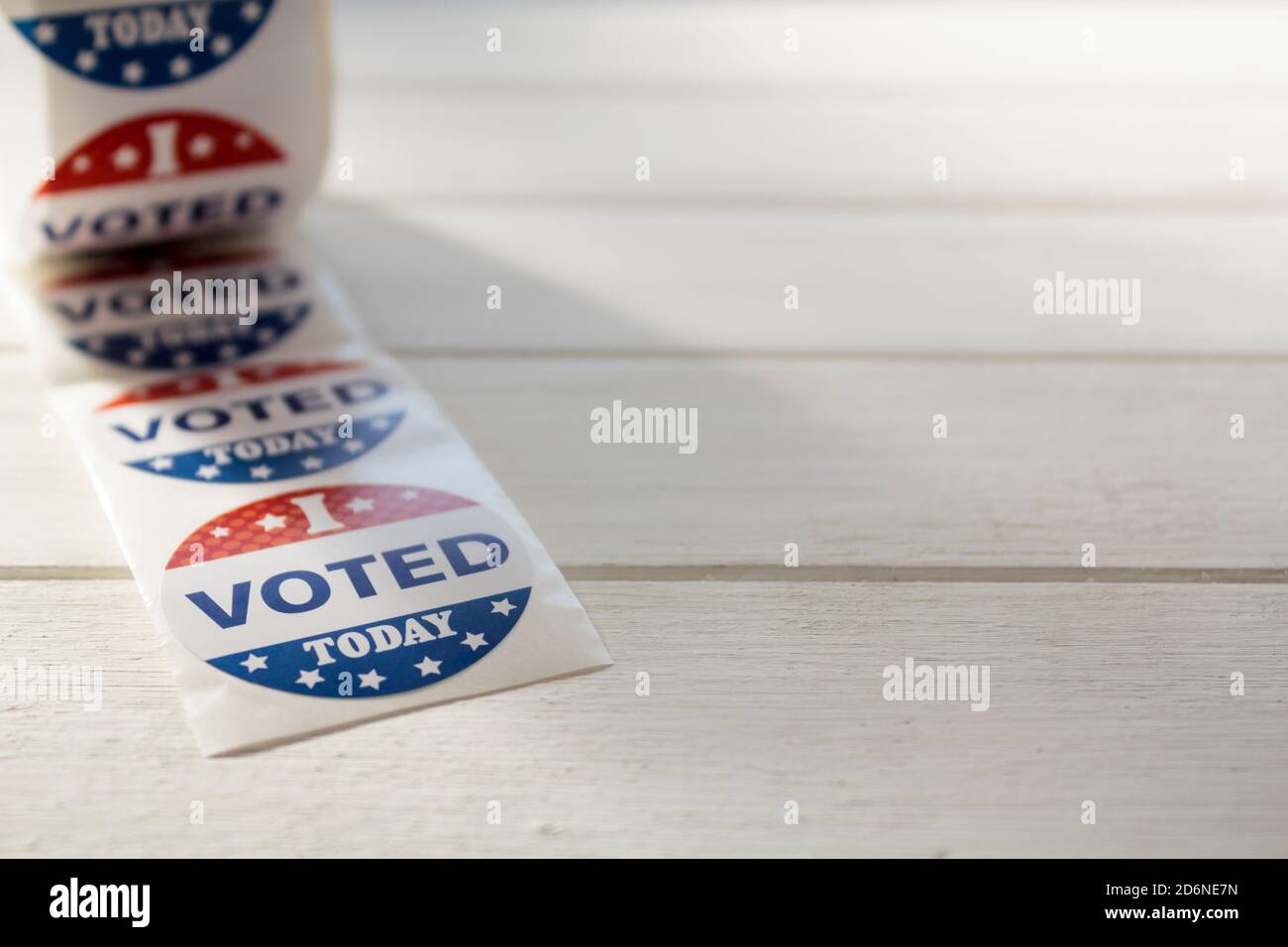 Roll of I Voted Today stickers on white wooden table with copy space ...