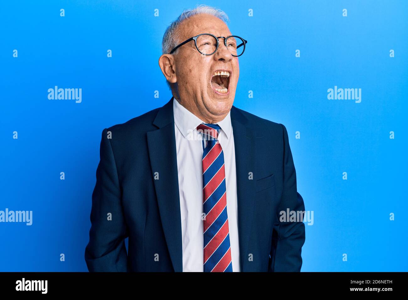 Senior caucasian man wearing business suit and tie angry and mad ...