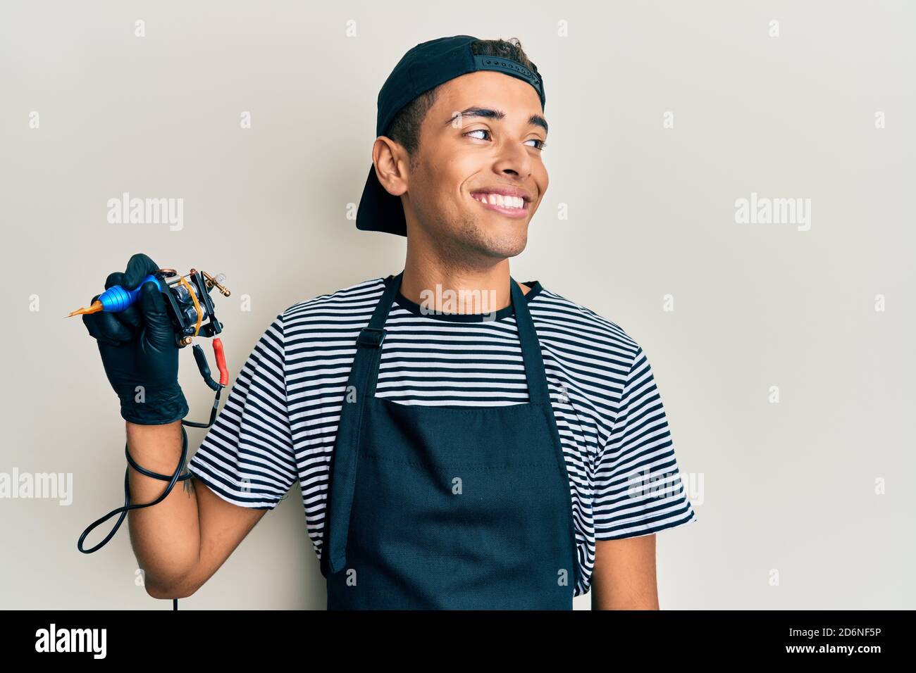 Young handsome african american man tattoo artist wearing professional ...