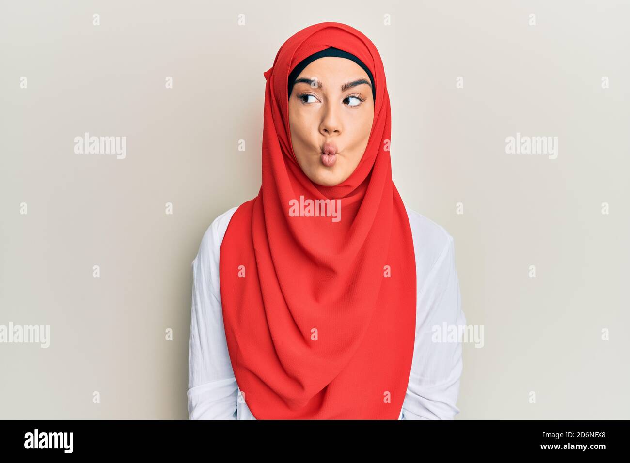 Young beautiful hispanic girl wearing traditional islamic hijab scarf ...