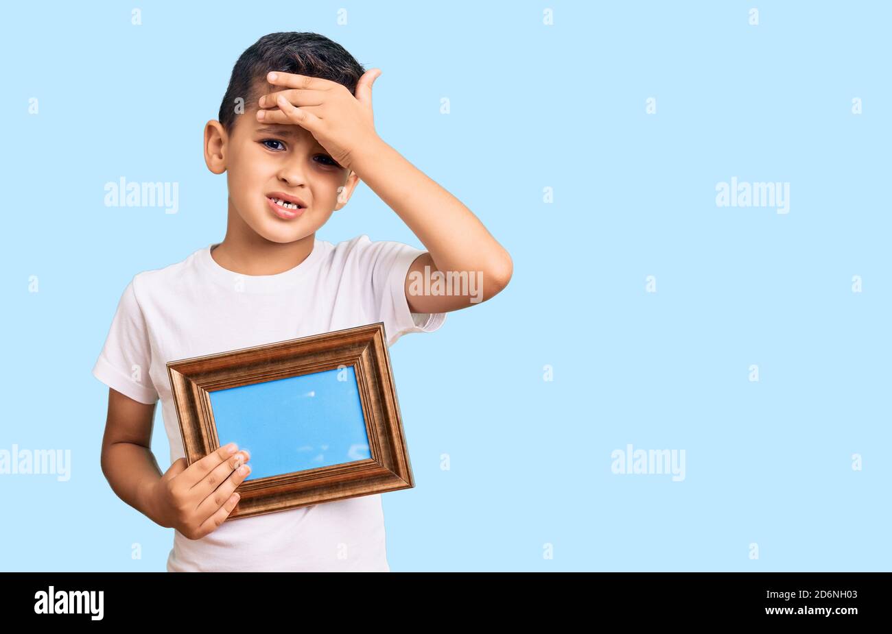 Little cute boy kid holding empty frame stressed and frustrated with ...