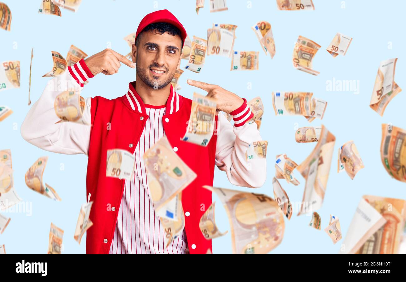 Young hispanic man wearing baseball uniform smiling cheerful showing ...