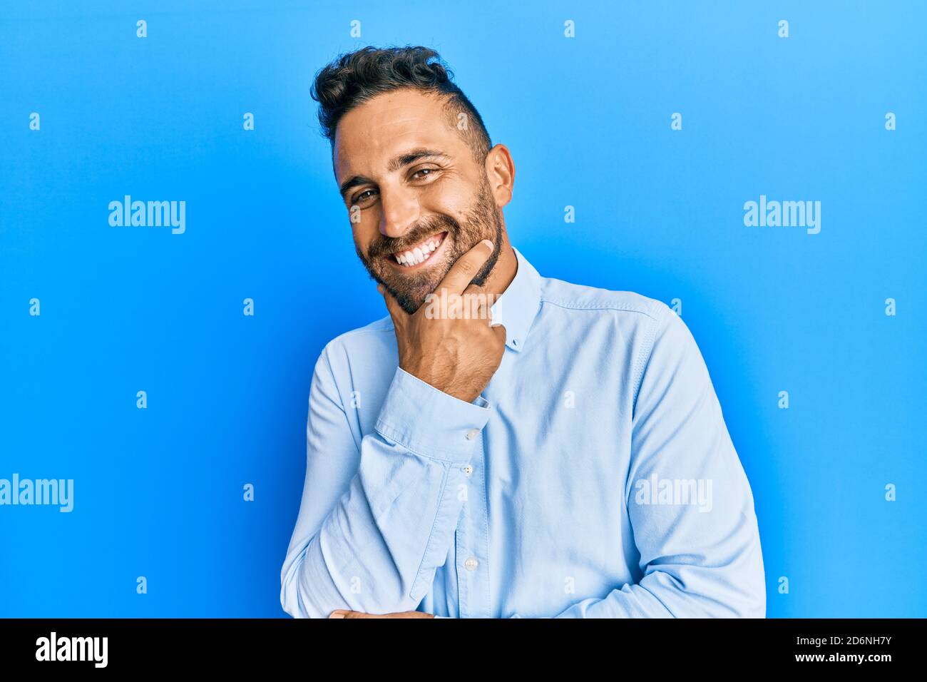 Handsome man with beard wearing casual clothes looking confident at the ...