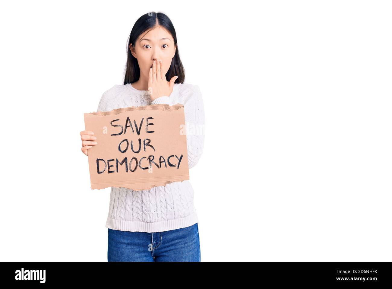 Young beautiful chinese woman holding save our democracy cardboard ...