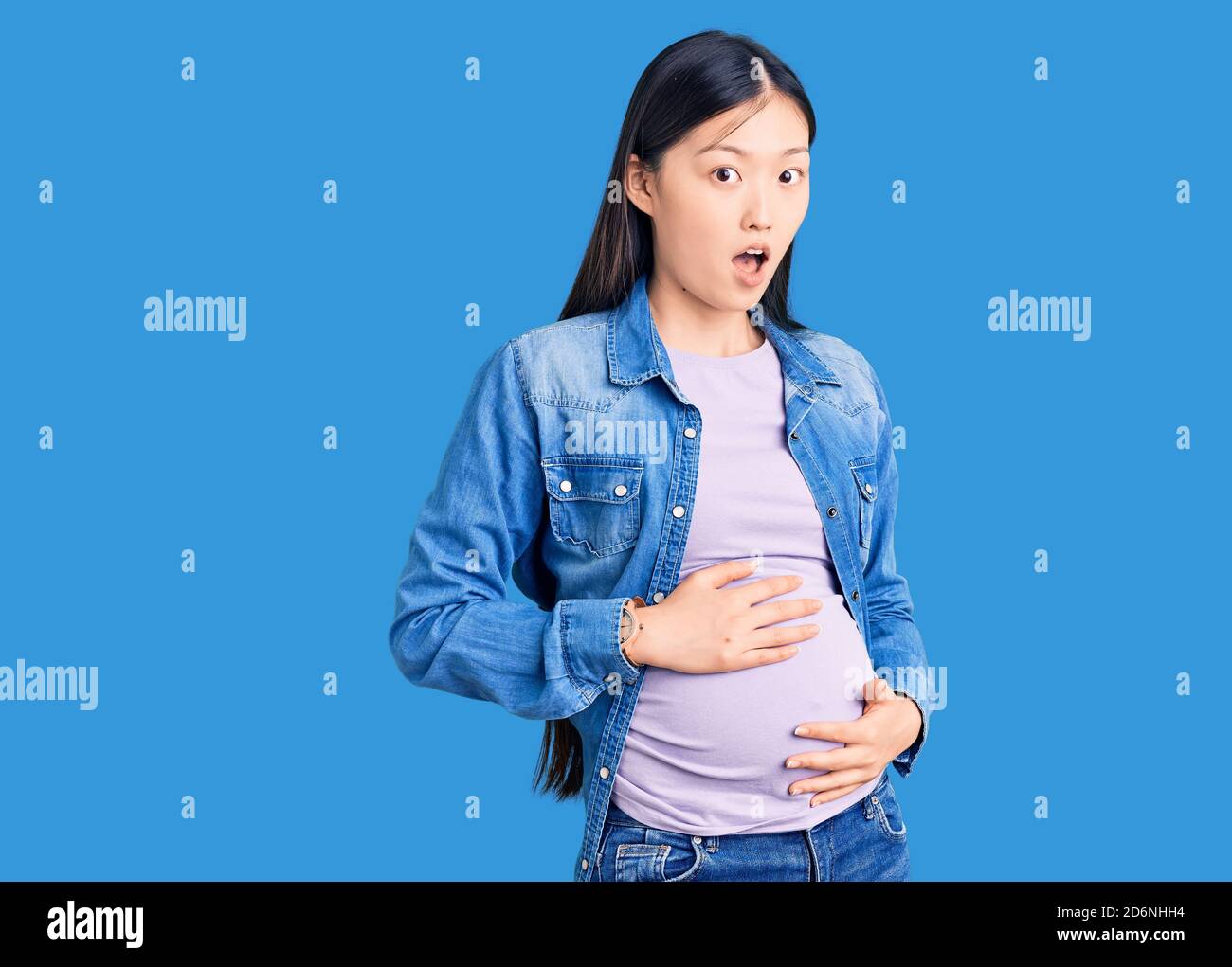 Young beautiful chinese woman pregnant expecting baby afraid and ...