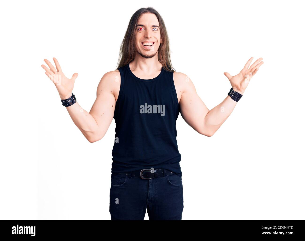 Young adult man with long hair wearing rocker style with black clothes ...