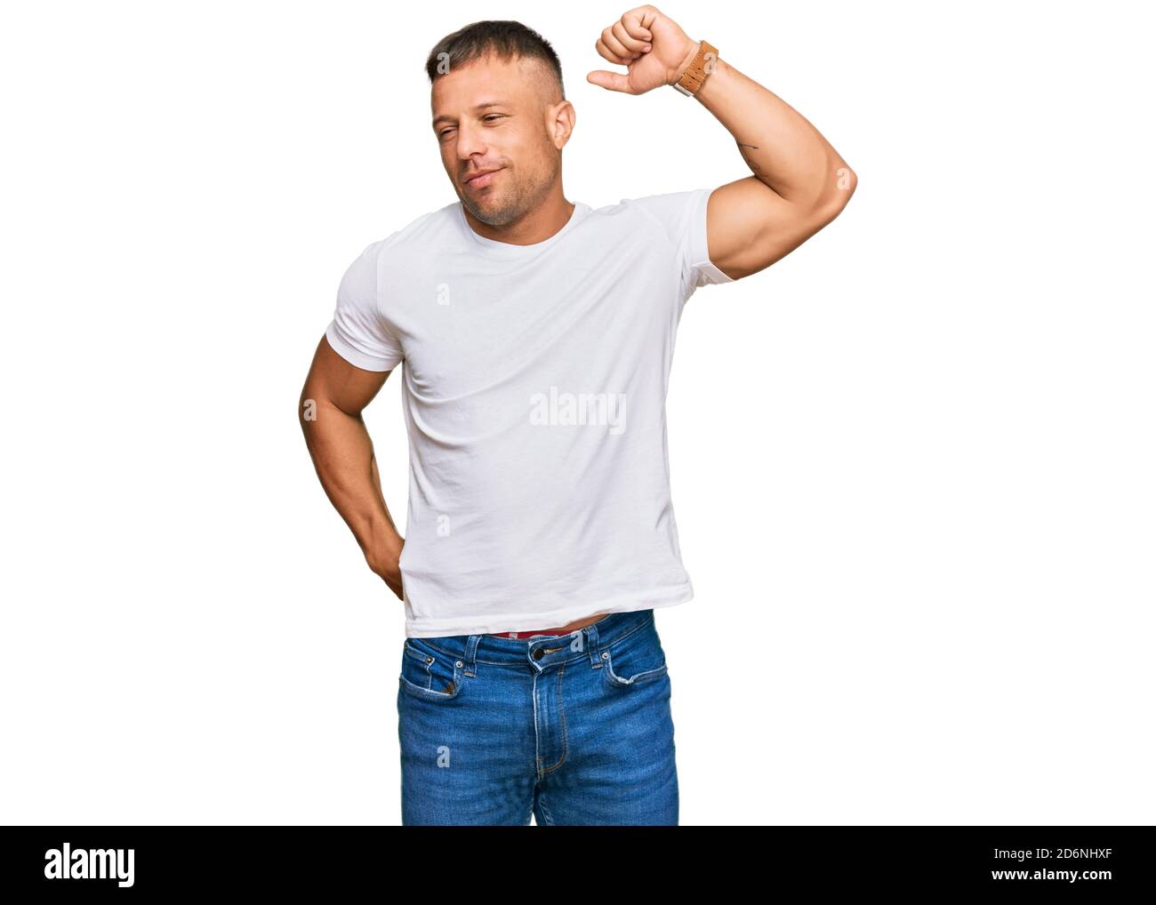 Handsome muscle man wearing casual white tshirt stretching back, tired ...