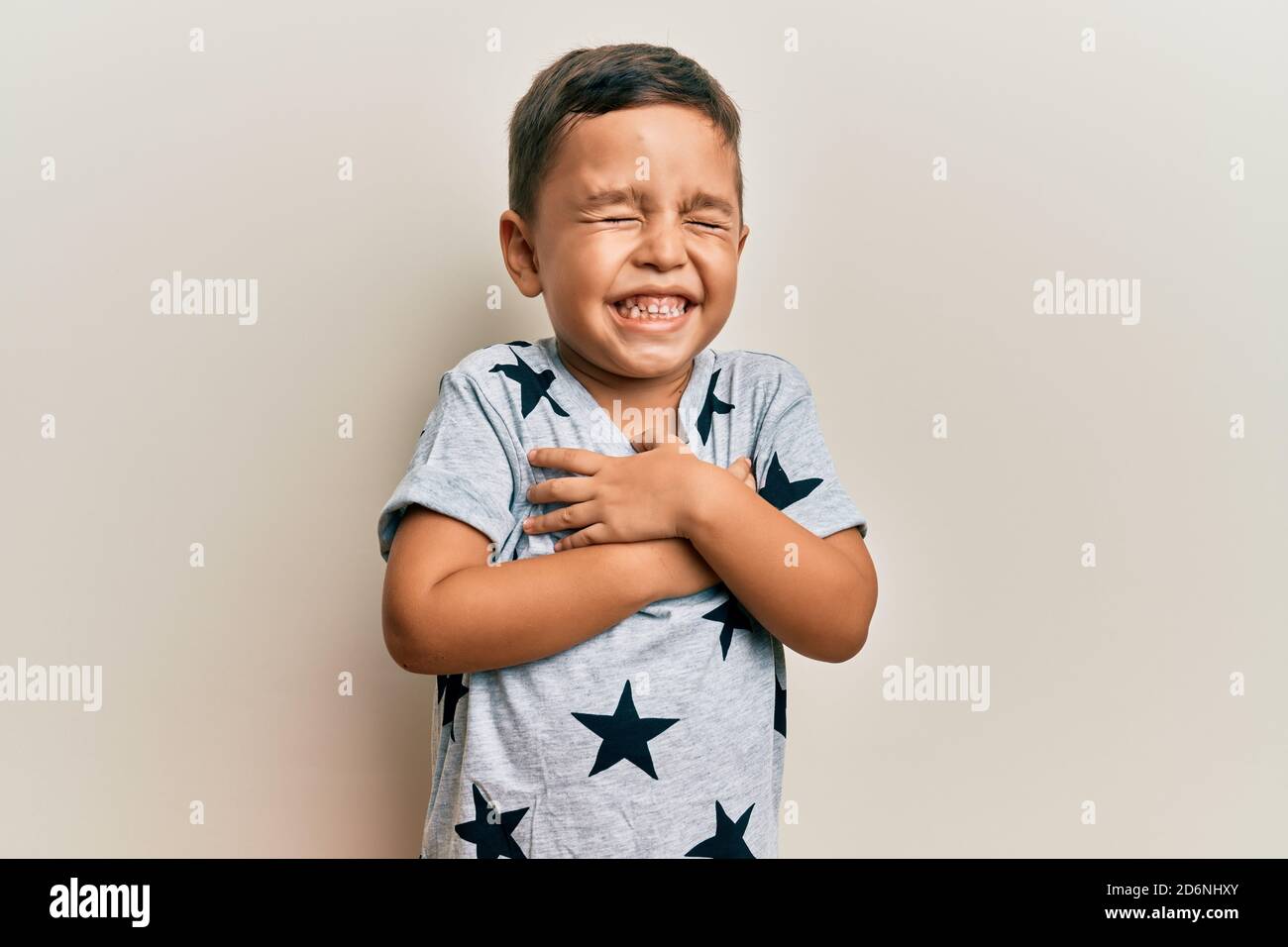 Adorable latin toddler wearing casual clothes smiling with hands on ...