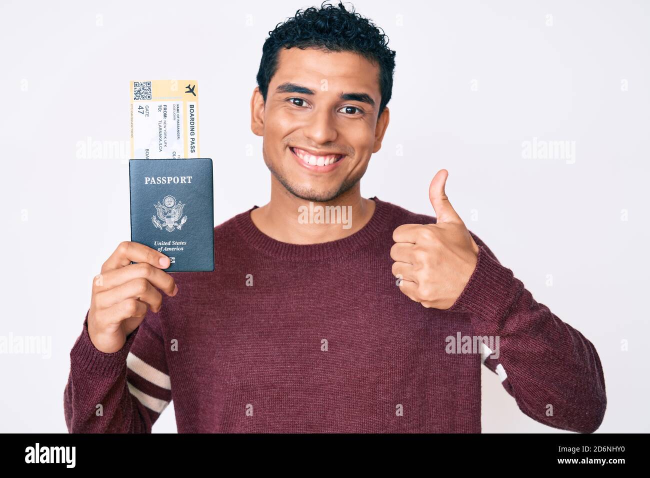 Young handsome hispanic man holding boarding pass and passport smiling ...