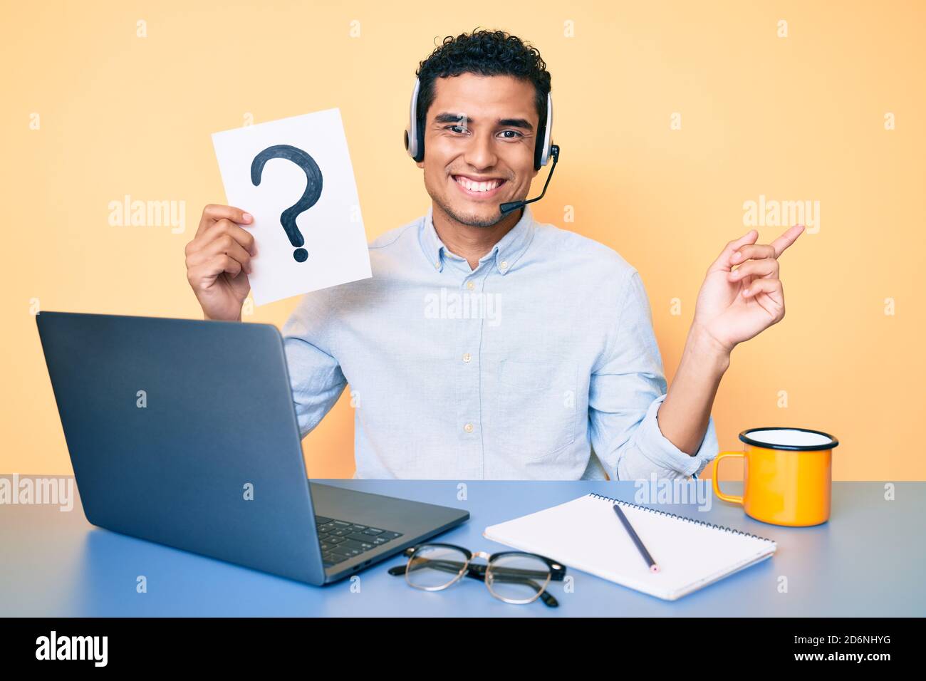 Young handsome hispanic man holding question mark as customer support ...