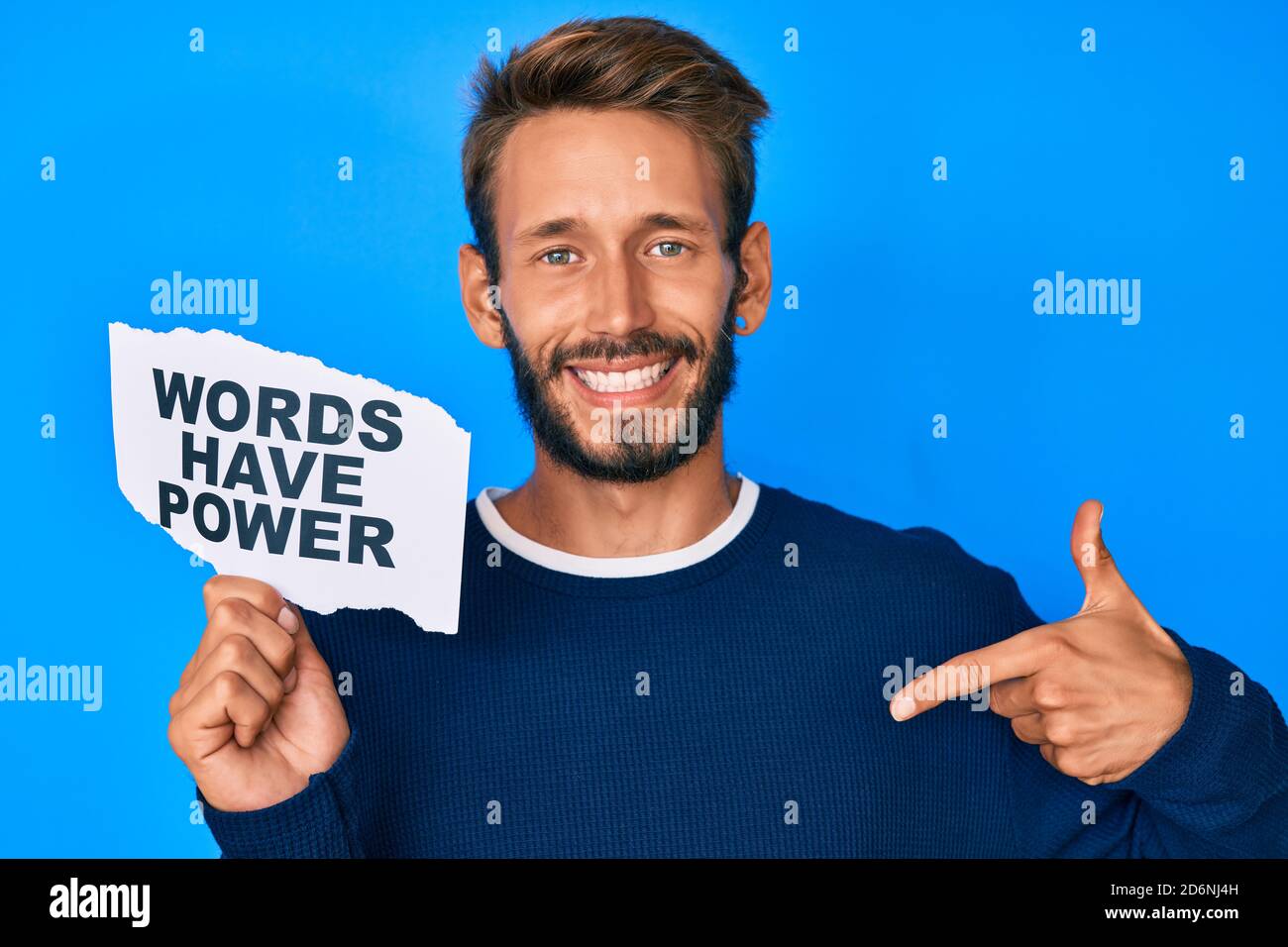 Handsome caucasian man with beard showing words have power banner ...