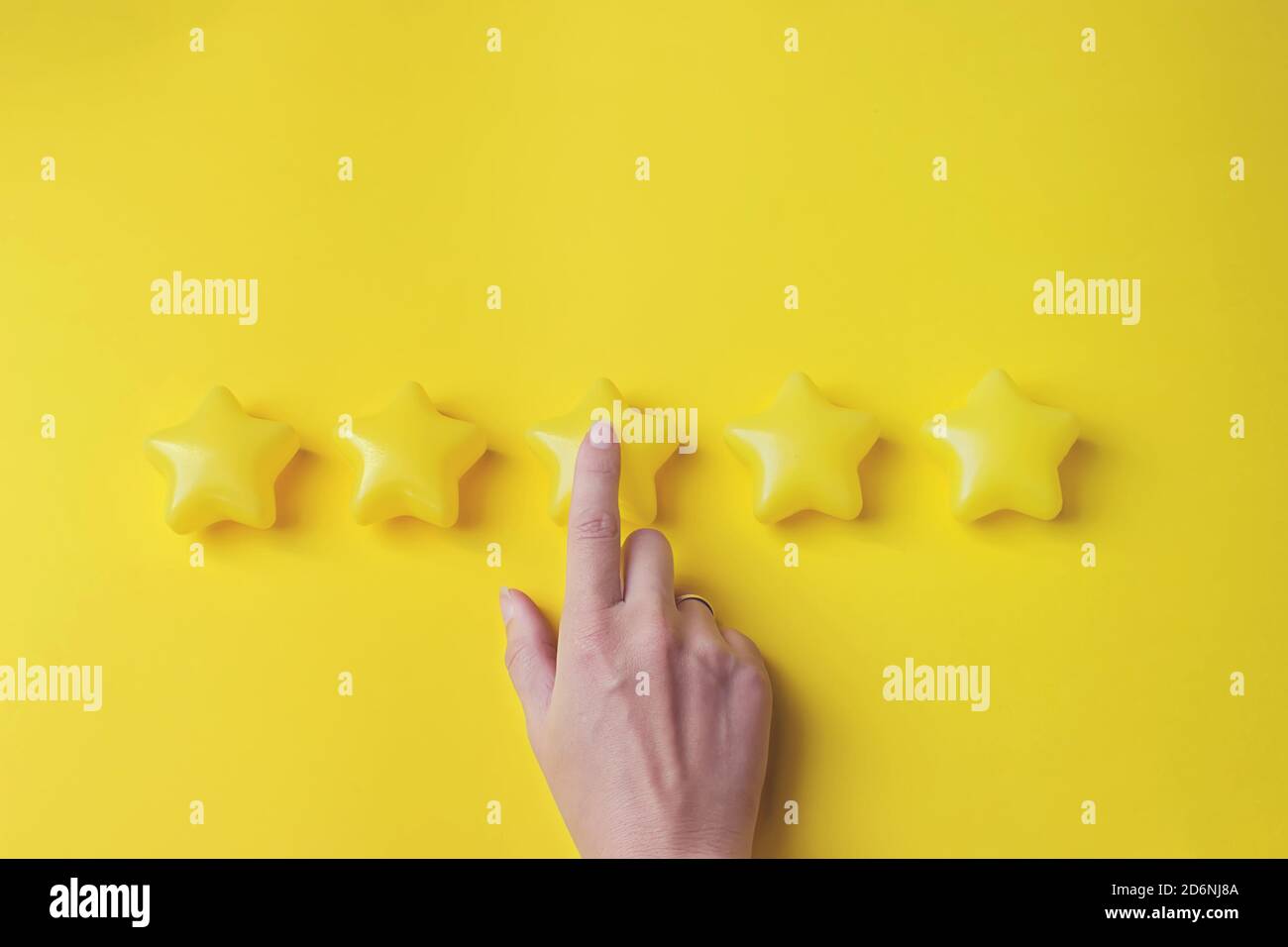 The concept of assessment. Hand pointing to five stars to increase the ...