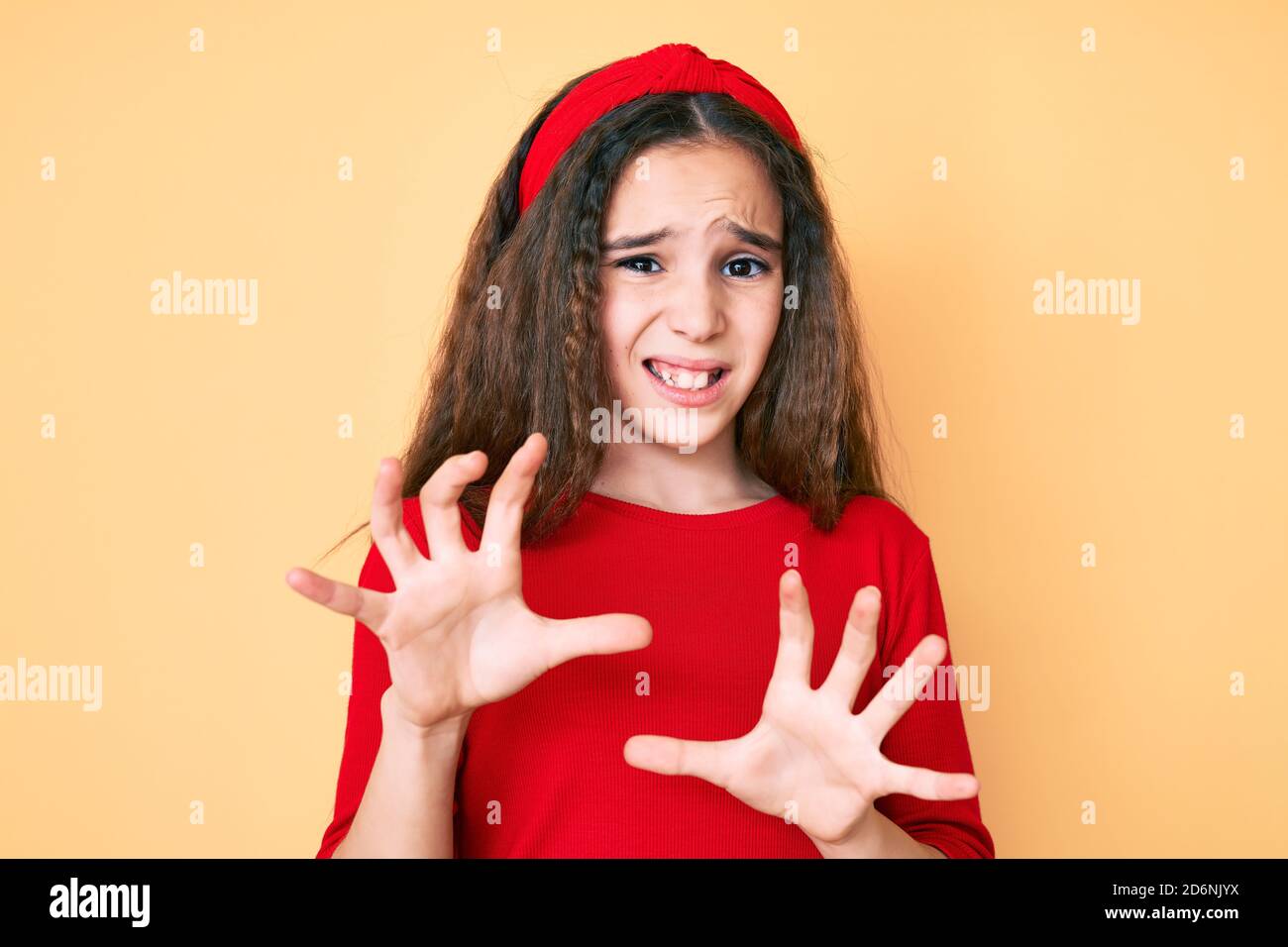 Cute hispanic child girl wearing casual clothes and diadem disgusted ...