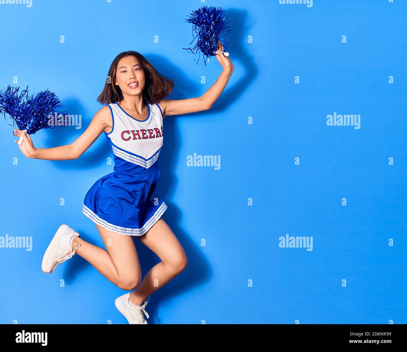 Young Beautiful Chinese Girl Smiling Happy Wearing Cheerleader Uniform