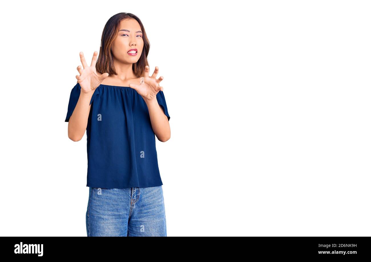 Young beautiful chinese girl wearing casual clothes disgusted ...