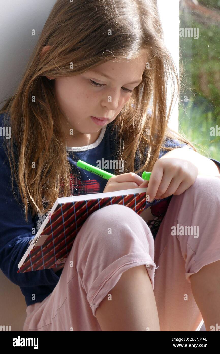 Little girl writing in her bedroom Stock Photo - Alamy