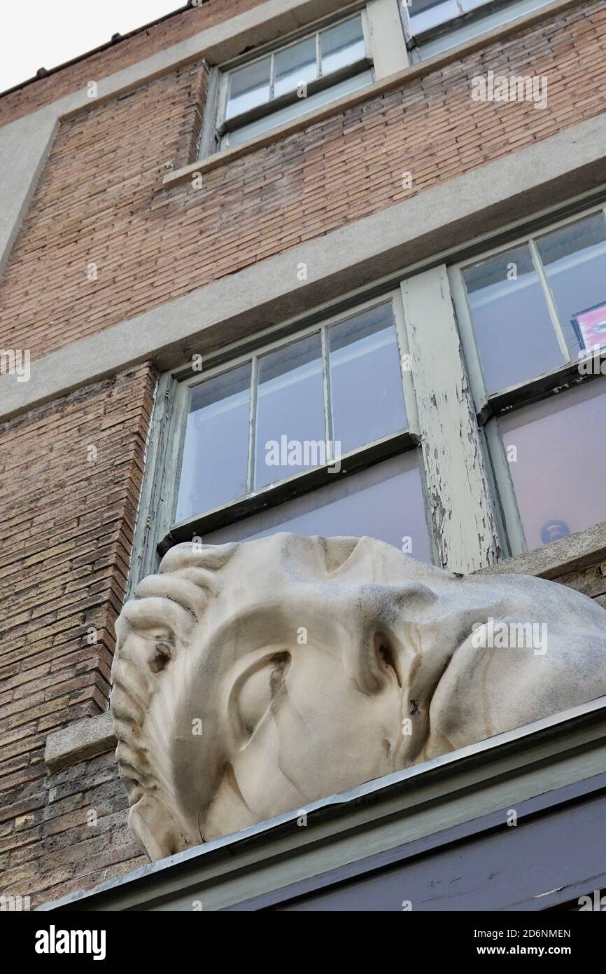 A sculpted head on the side of a building Stock Photo - Alamy