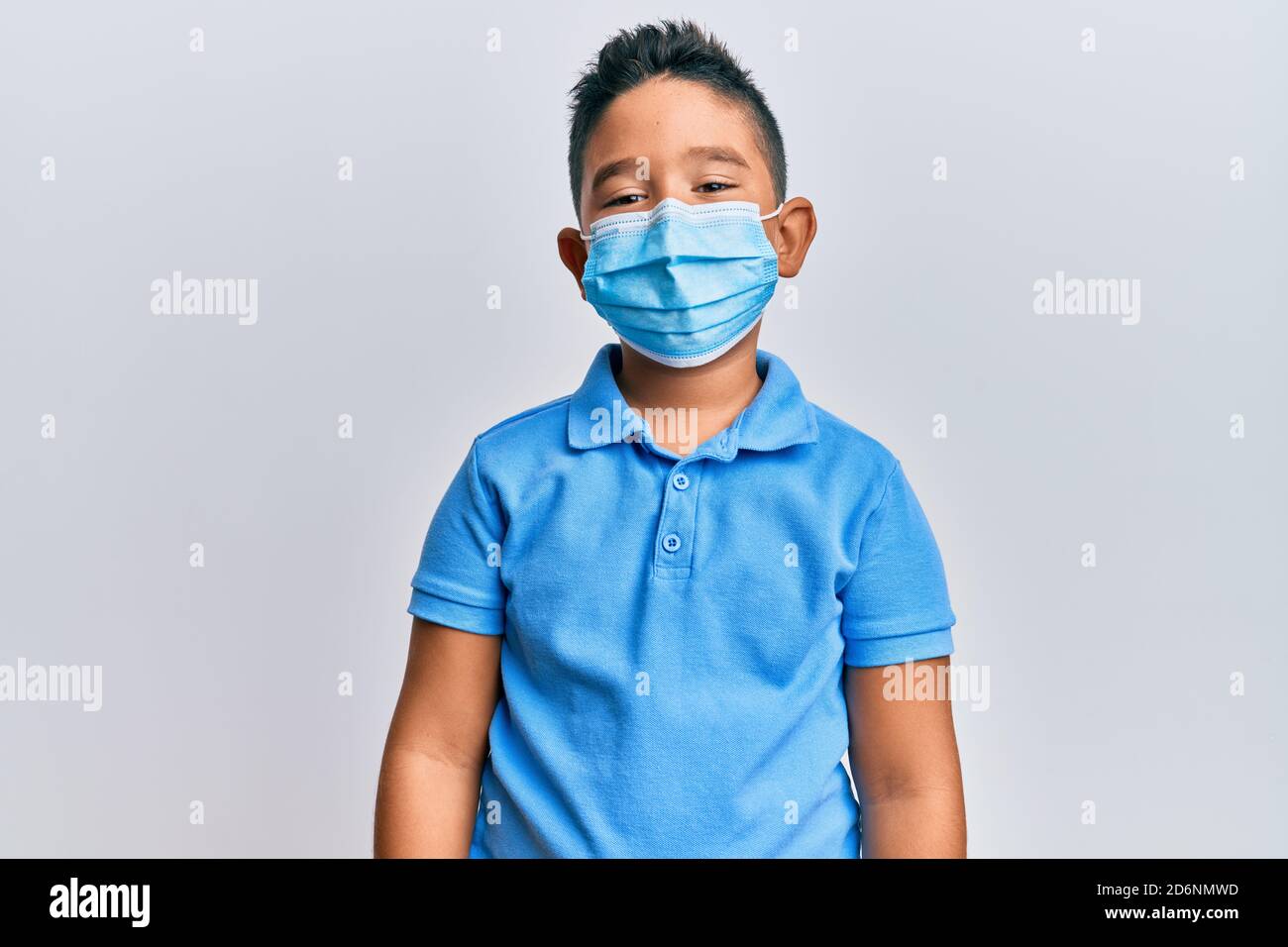 Little boy hispanic kid wearing medical mask with a happy and cool ...