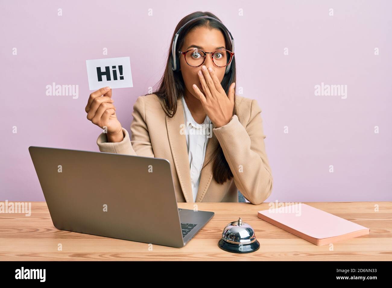 Beautiful hispanic woman wearing operator headset holding hi paper ...