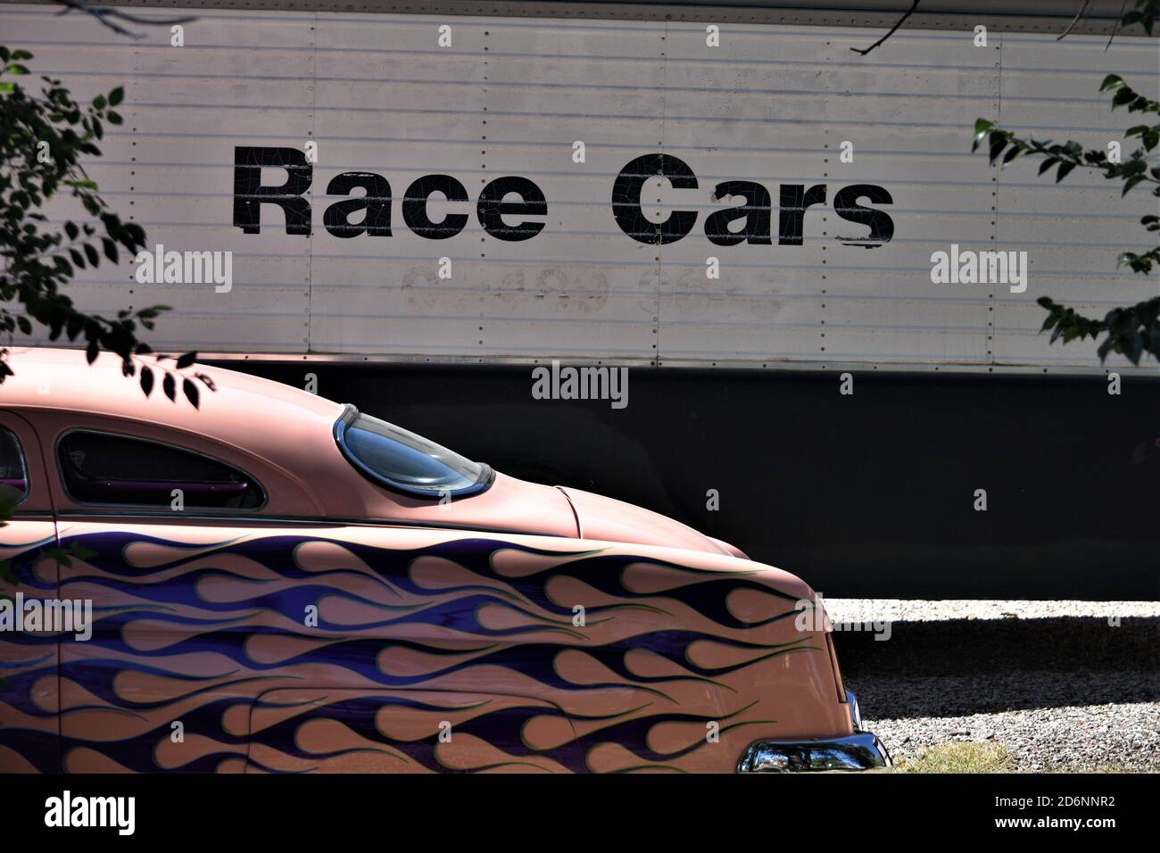 Race car trailer parked behind a custom hot rod Stock Photo - Alamy