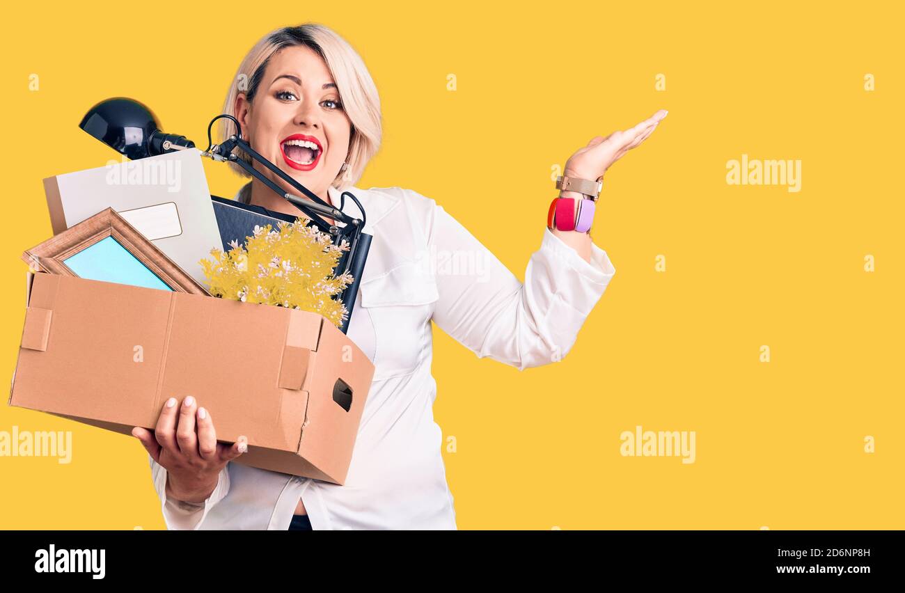 Young blonde plus size woman fired holding box celebrating victory with ...