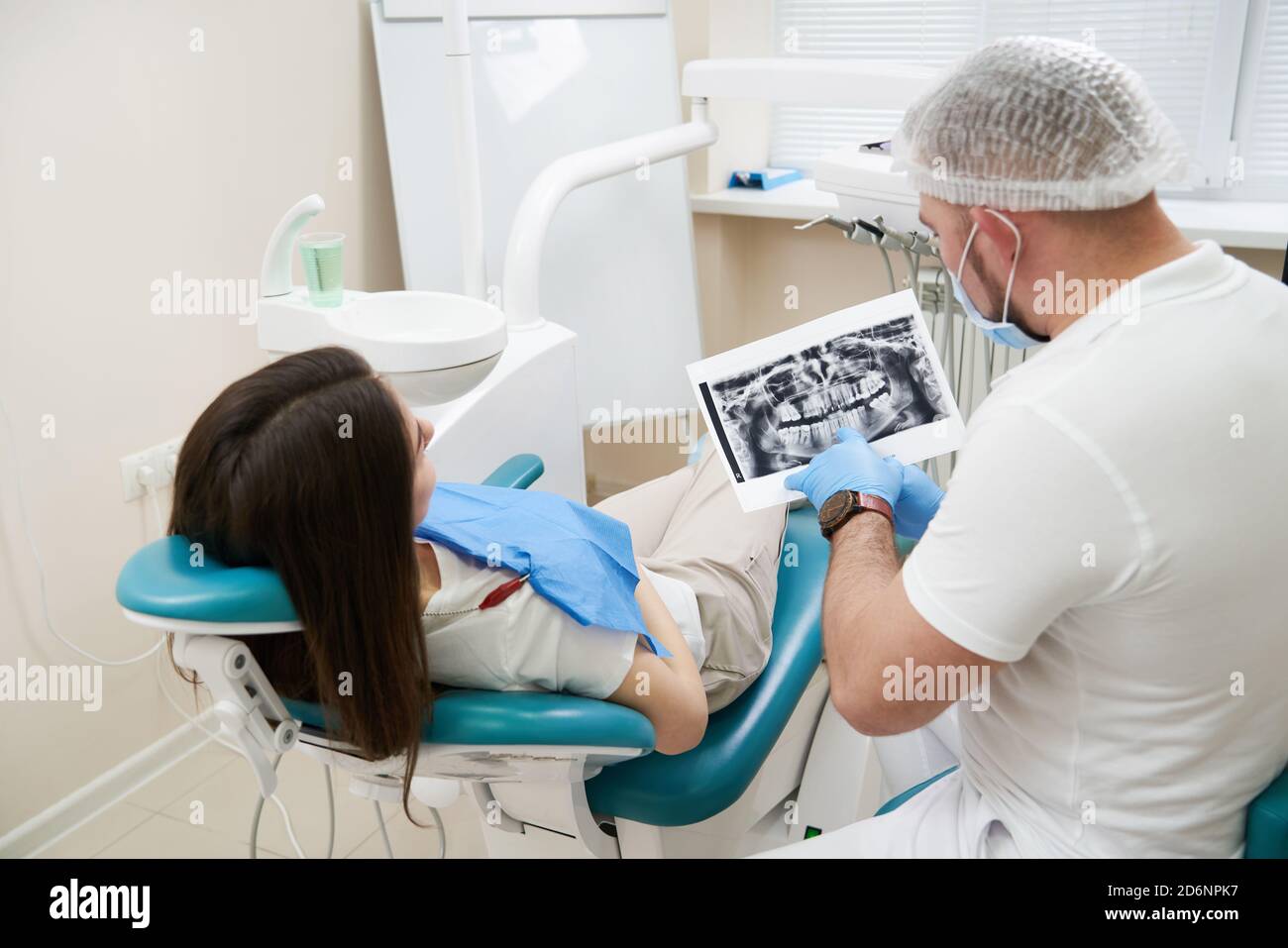 Doctor shows the patient an x-ray image. Computer diagnostics. dental ...
