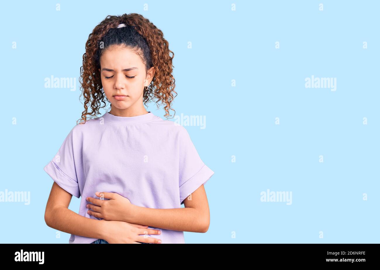 Beautiful kid girl with curly hair wearing casual clothes with hand on ...
