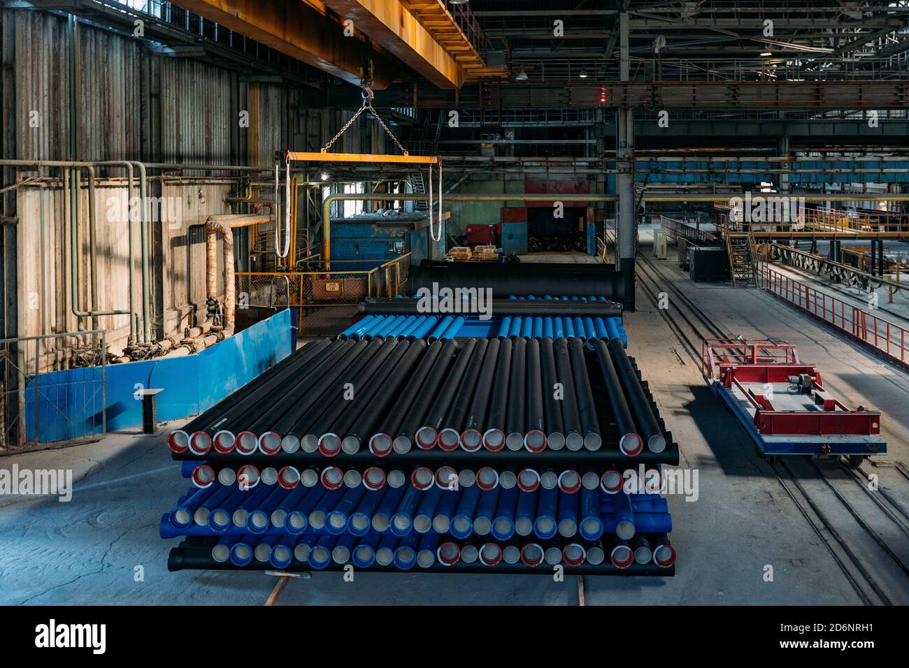 New cast iron pipes for pipeline construction in warehouse Stock Photo ...