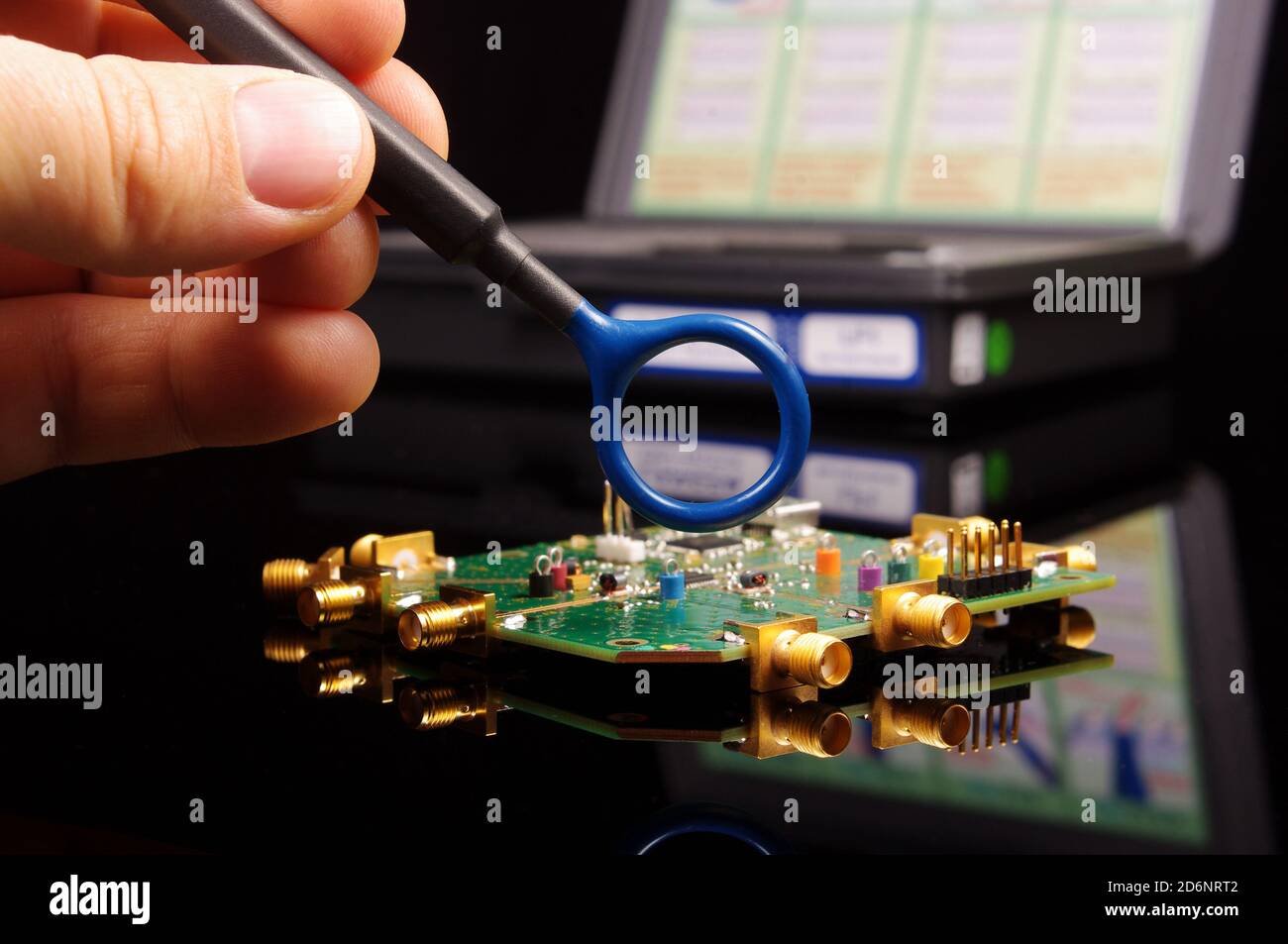 Electromagnetic compatibility (EMC) engineer holding magnetic near ...