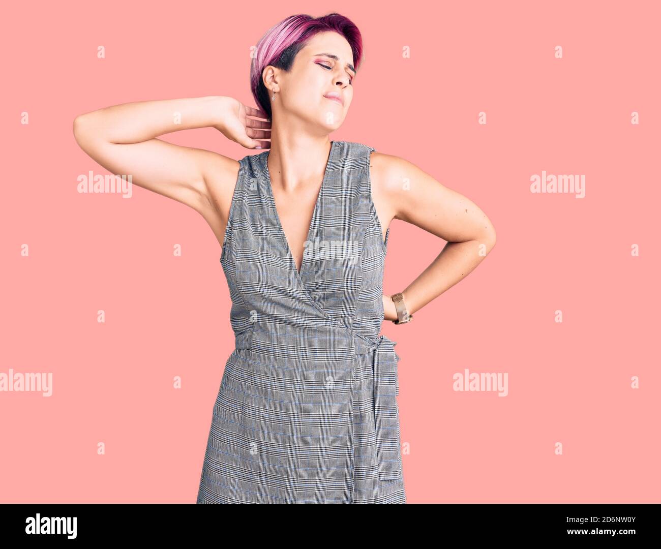 Young beautiful woman with pink hair wearing casual clothes suffering ...