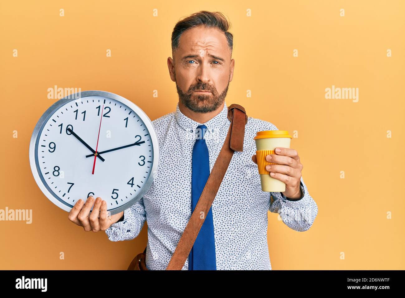 Handsome middle age business man drinking a cup of coffee and holding ...