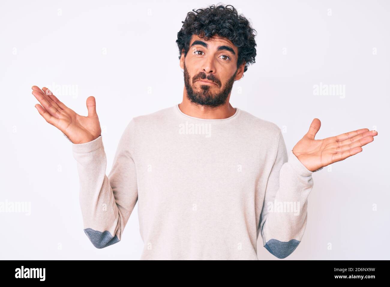 Handsome young man with curly hair and bear wearing casual winter ...