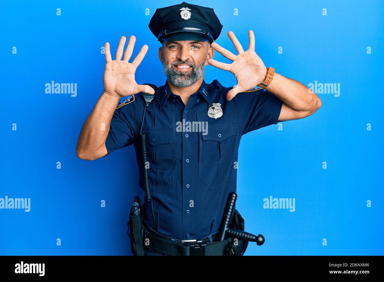 Middle age handsome man wearing police uniform showing and pointing up ...