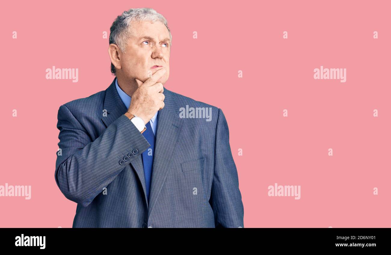 Senior grey-haired man wearing business jacket thinking worried about a ...