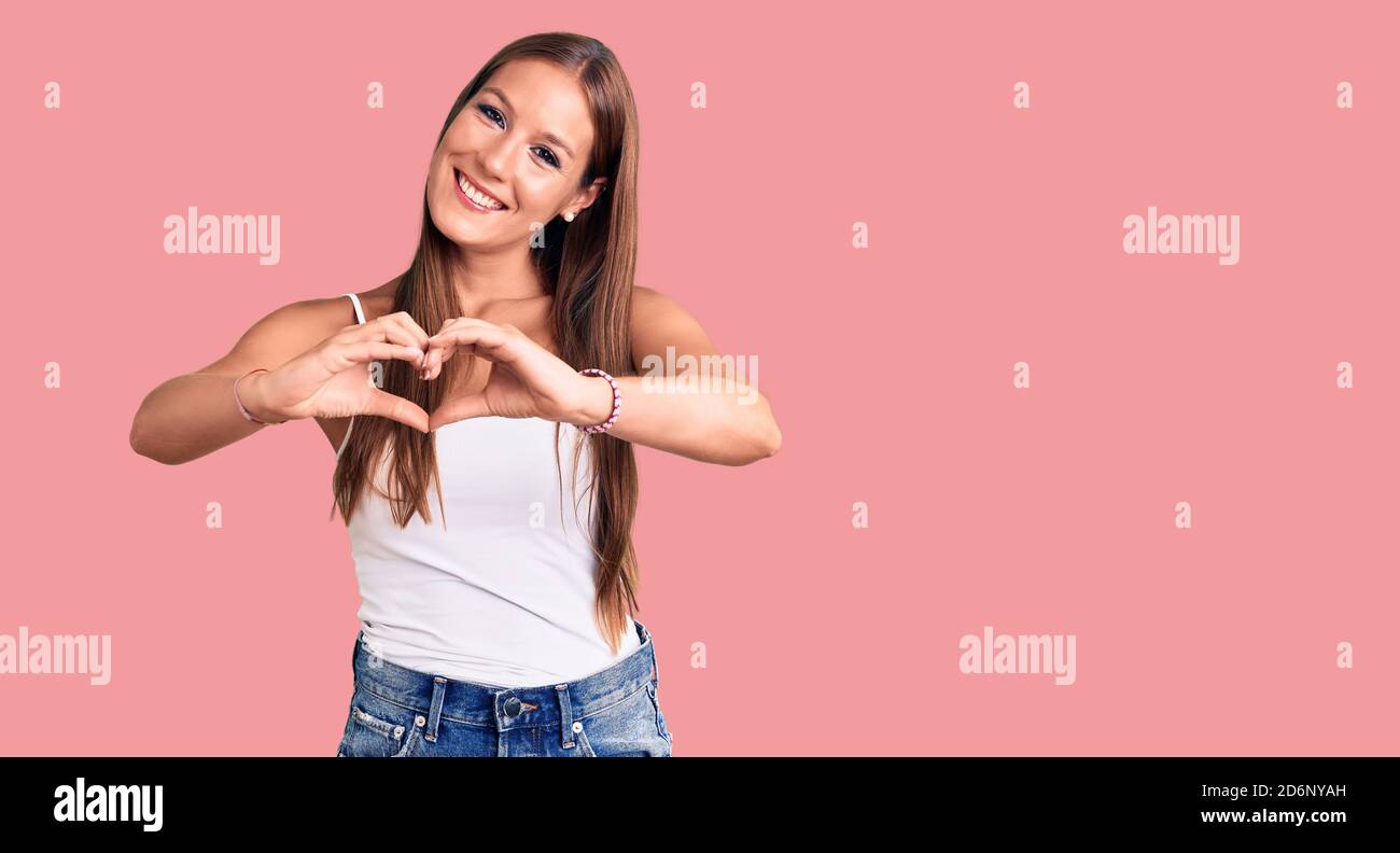 Young beautiful hispanic woman wearing casual clothes smiling in love ...