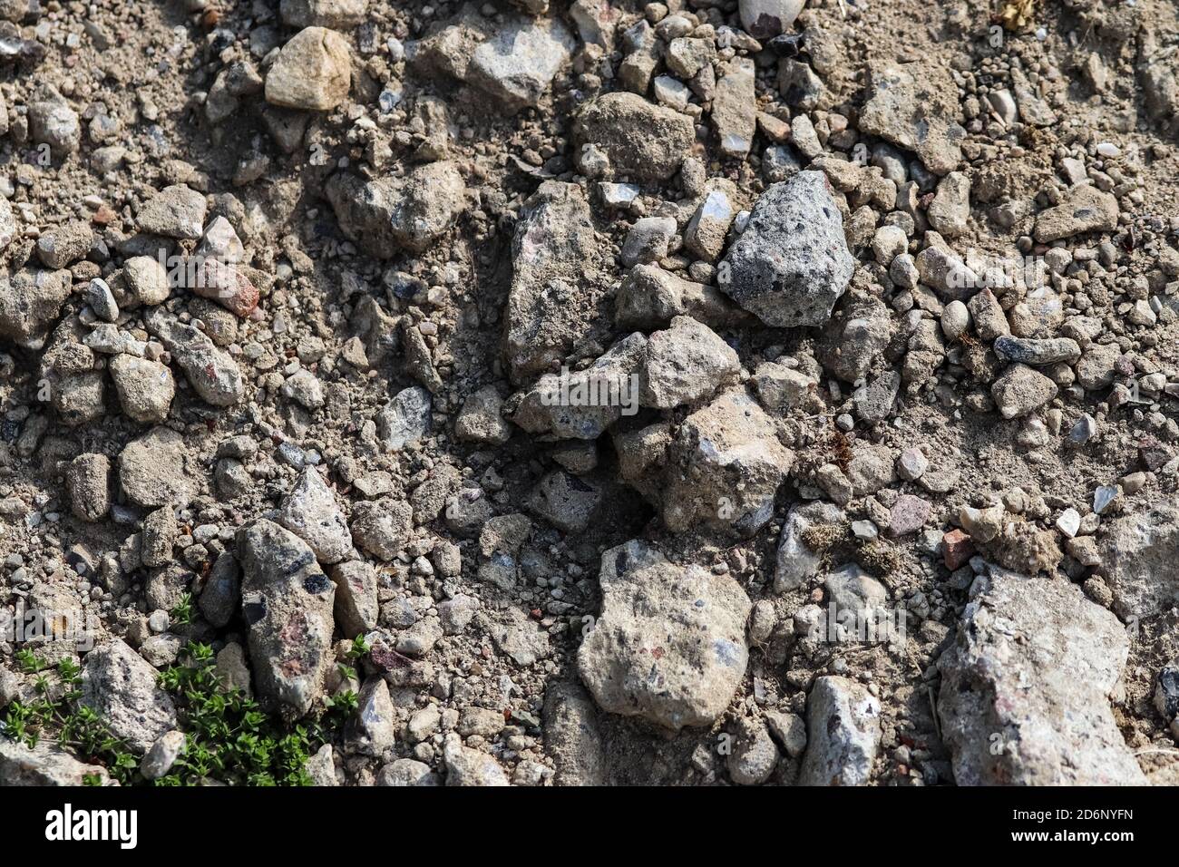 Detailed close up view on pebbles and stones on a gravel ground texture ...