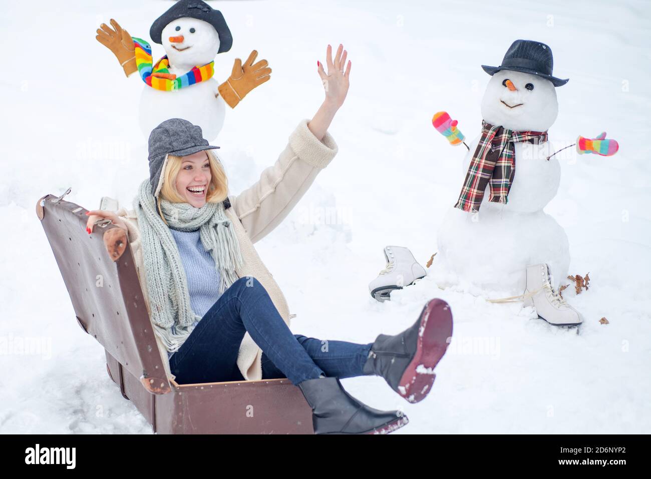 Happy smiling snow man and winter girl on sunny winter day. Winter ...