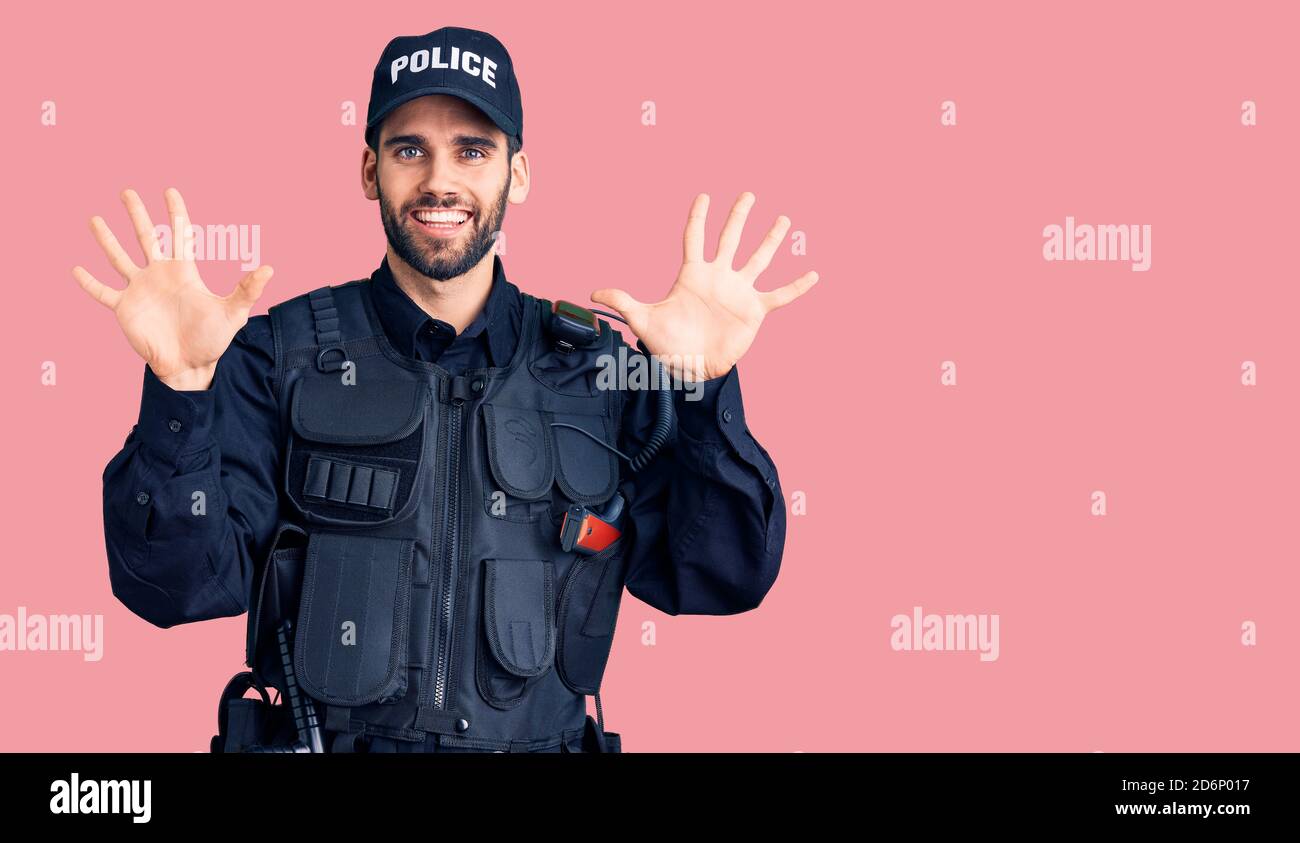 Young handsome man with beard wearing police uniform showing and ...