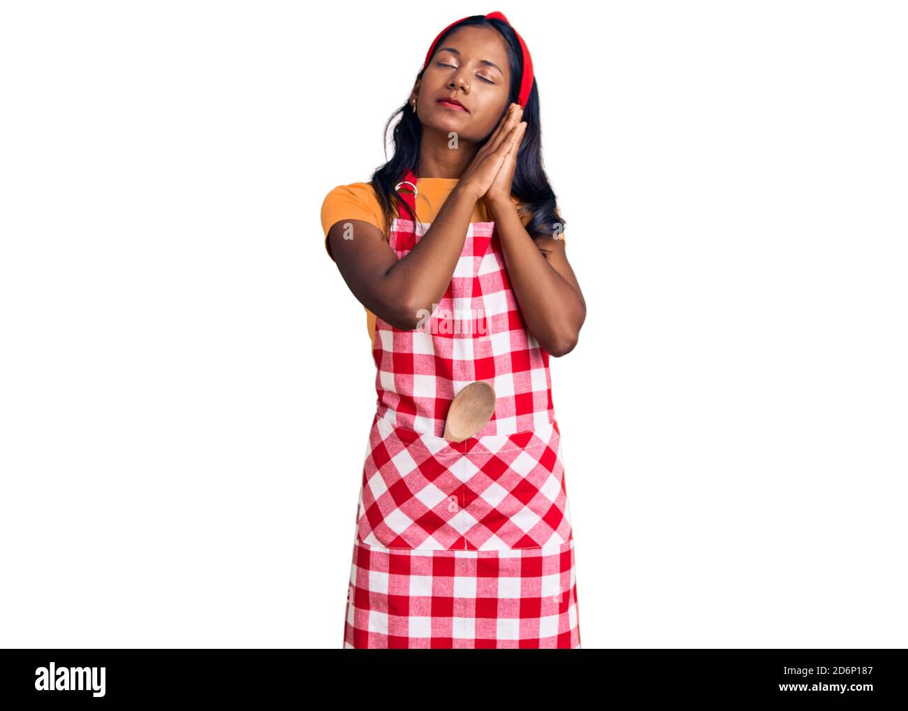 Young indian girl wearing professional baker apron sleeping tired ...