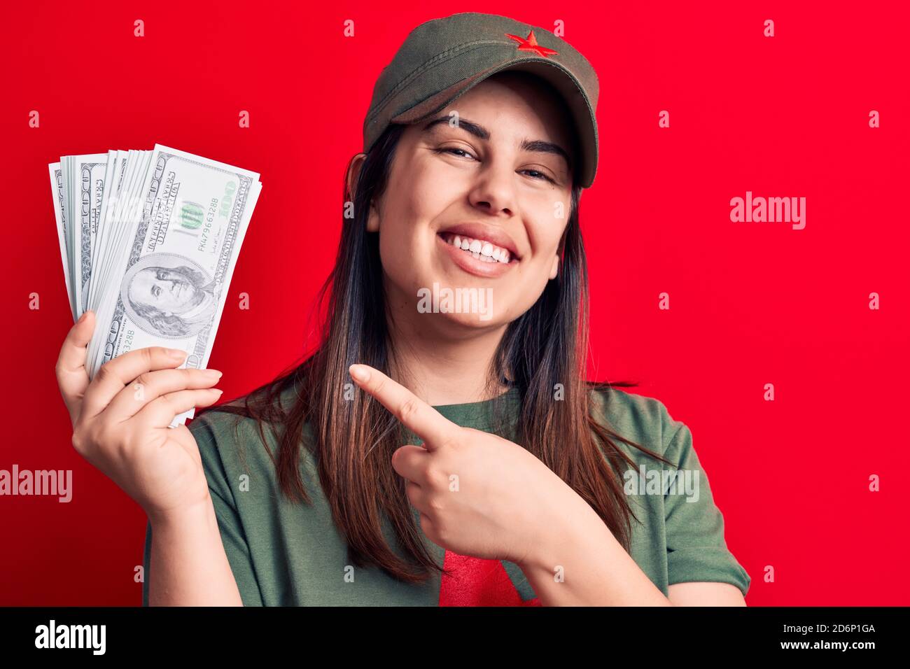Woman wearing t-shirt with red star communist symbol holding bunch of ...