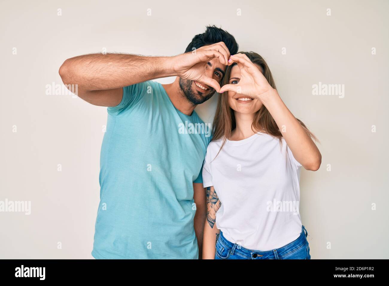Beautiful young couple of boyfriend and girlfriend together doing heart ...