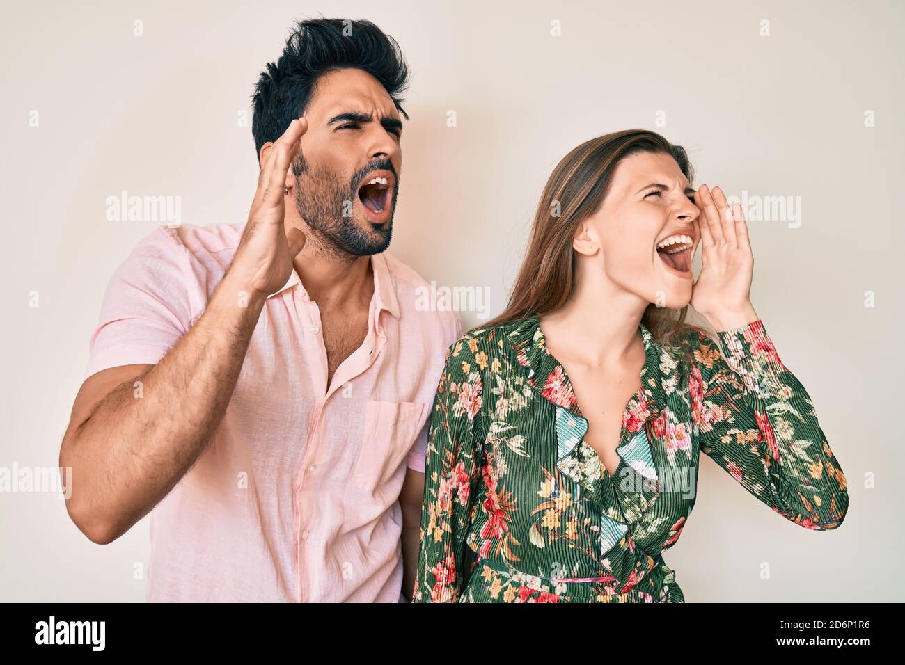 Beautiful young couple of boyfriend and girlfriend together shouting ...