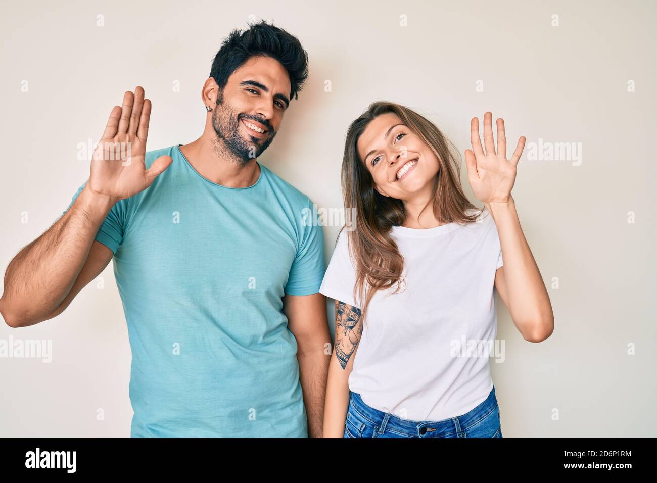 Beautiful young couple of boyfriend and girlfriend together waiving ...