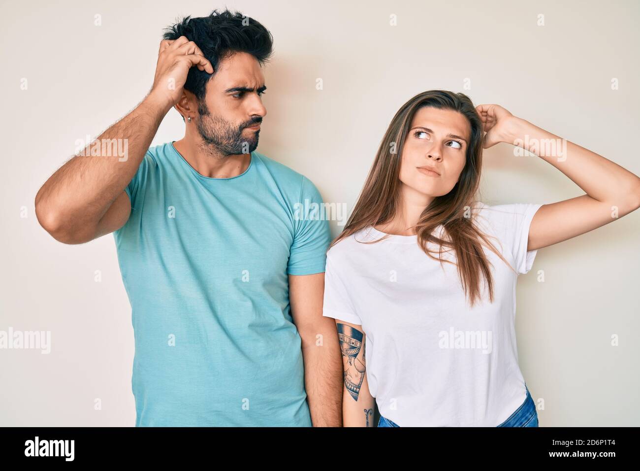 Beautiful young couple of boyfriend and girlfriend together confuse and ...