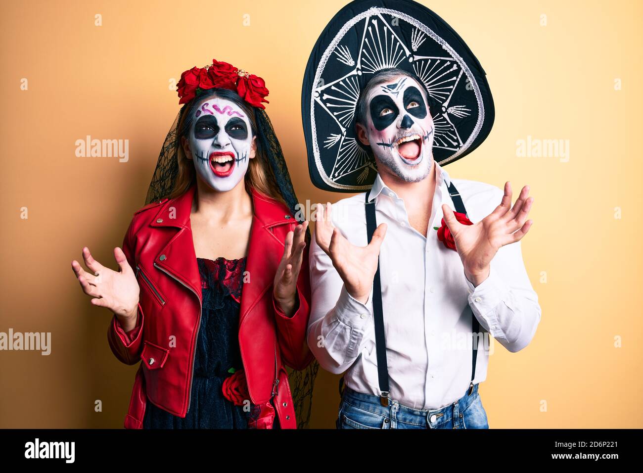 Couple wearing day of the dead costume over yellow crazy and mad ...