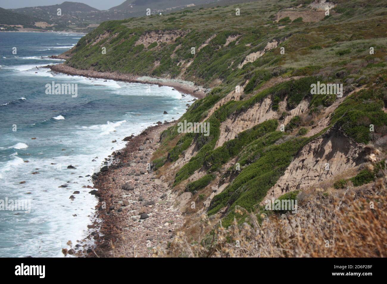 Aerial shot of a cliffy shore near the wavy sea at daytime Stock Photo ...