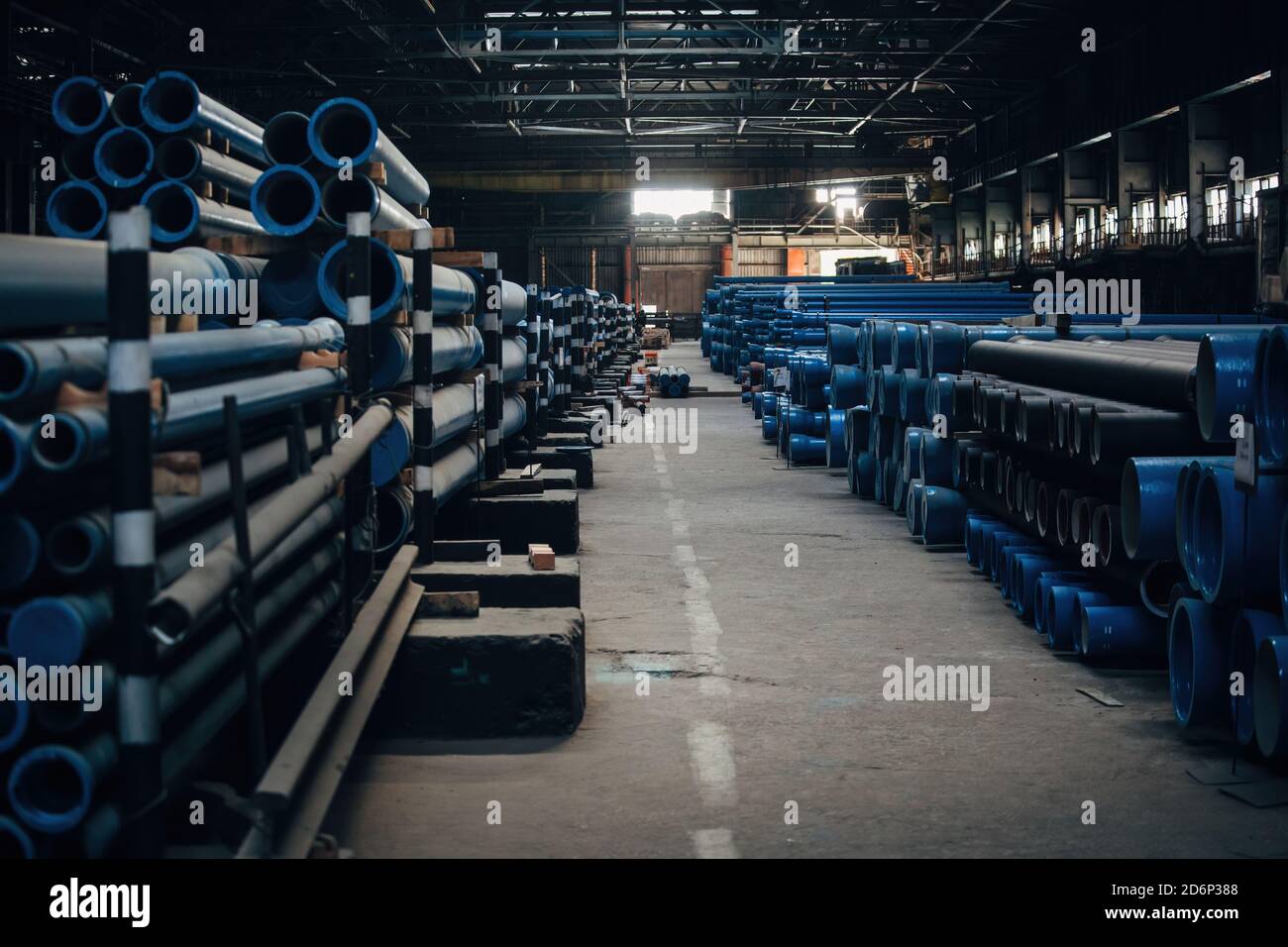 New cast iron pipes for pipeline construction in warehouse Stock Photo ...