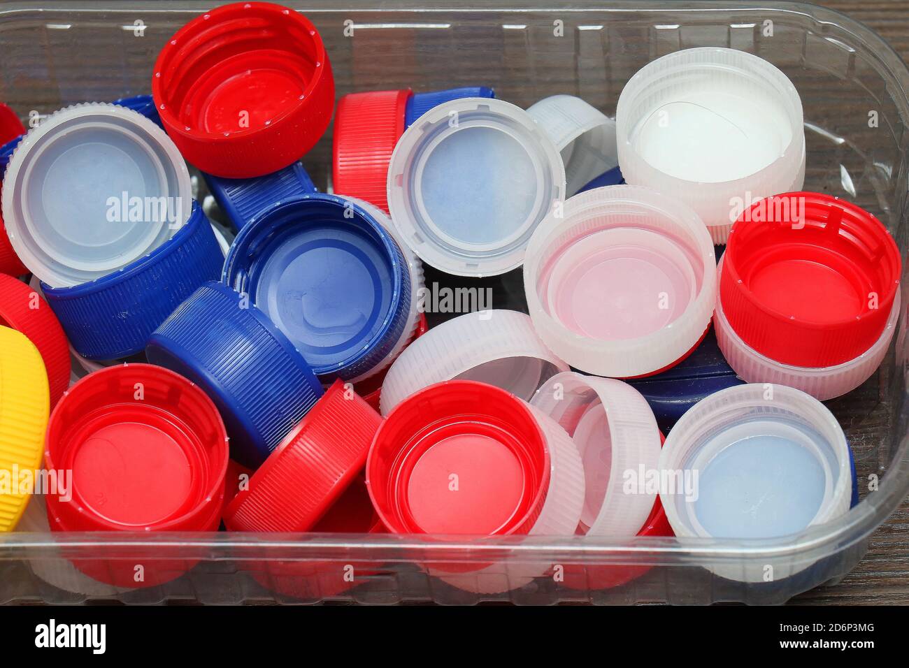 Colorful plastic bottle caps pile inside plate Stock Photo - Alamy