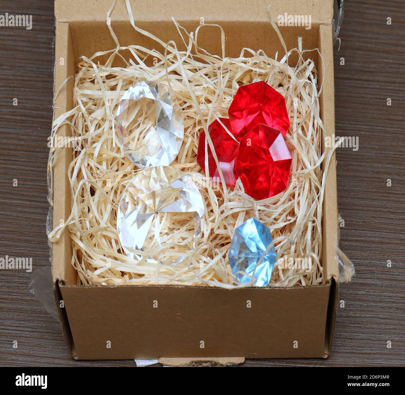 Colorful sparkling diamonds inside box with paper used to isolate and ...