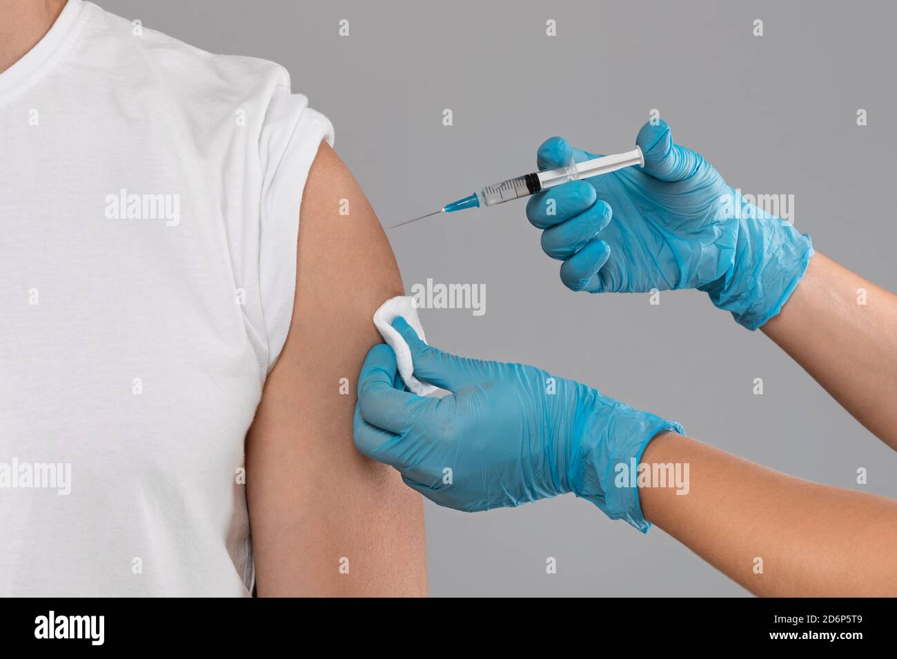 Doctor injecting vaccination in arm of man patient Stock Photo - Alamy